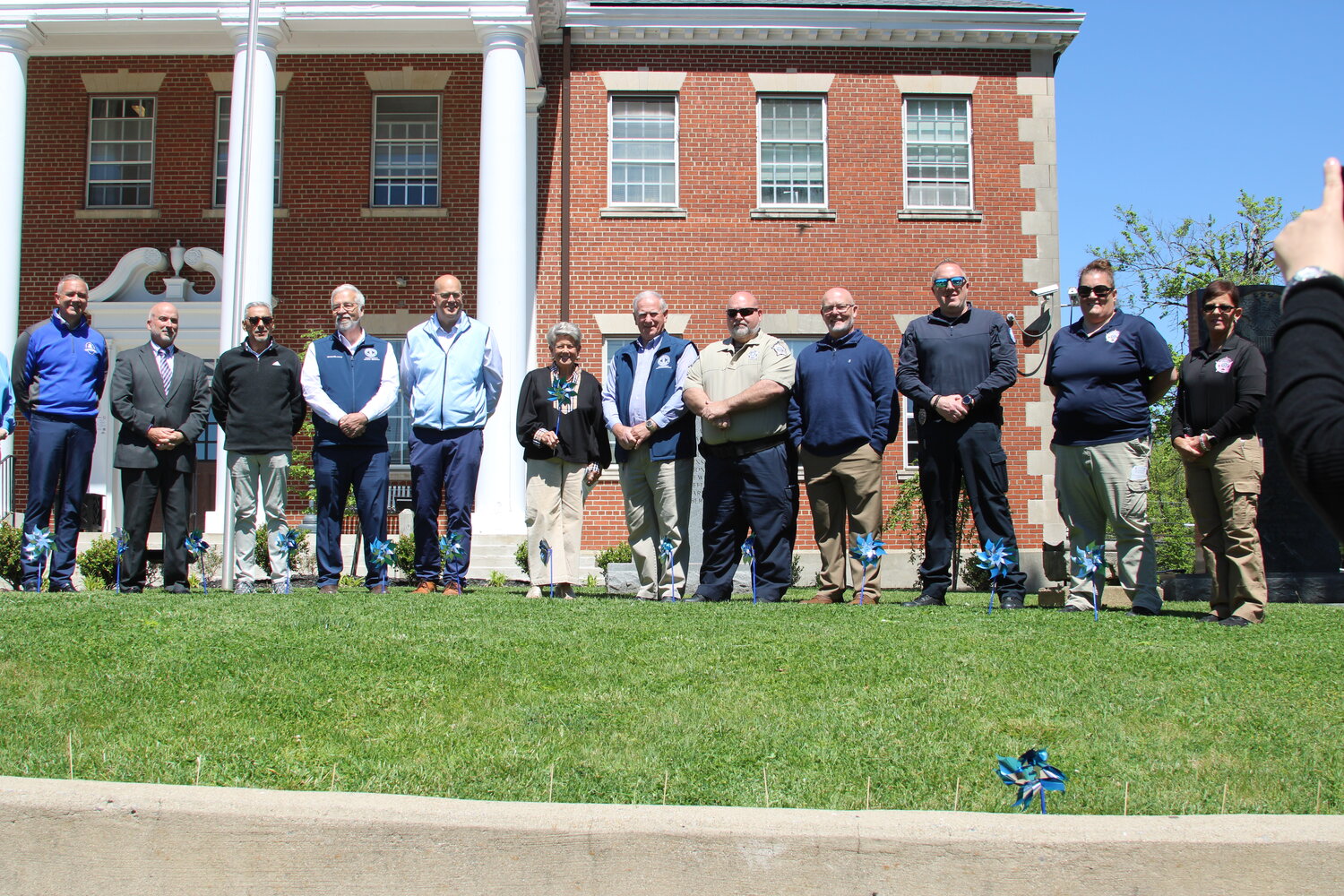 Officials gather for Child Abuse Prevention ceremony; pinwheels planted ...