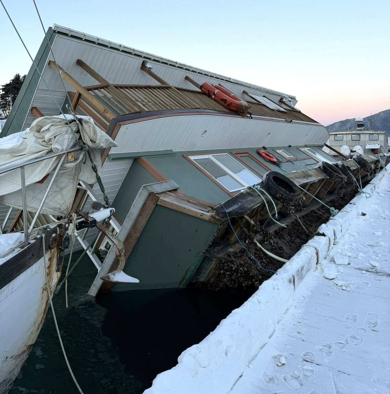 Crews rescue half-sunken camp barge at Reliance dock - Wrangell Sentinel